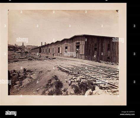 This Historical Photograph Shows Warehouses In A Railroad Yard Reflecting The Industrial Past
