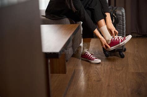 Woman Sitting On A Sofa And Takes Off Her Shoes Stock Image Image Of