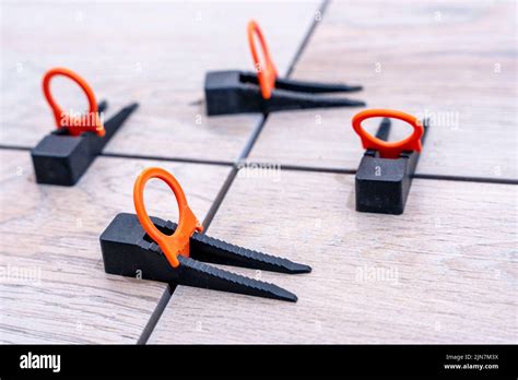 Close Up Of The Tile Alignment System Holding Tile In Given Position