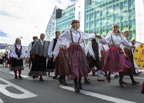 Estonian People In Traditional Clothing Walking The Streets Of Tallinn