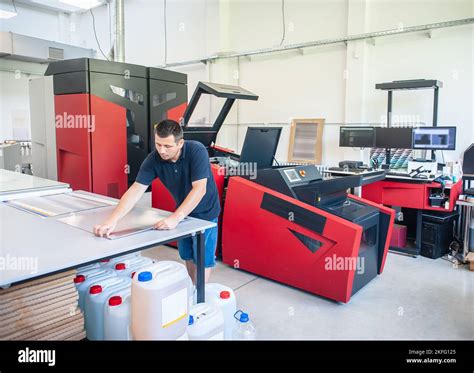 Professional Worker With Modern Big Offset Printing Machine In Print House Printing Industry