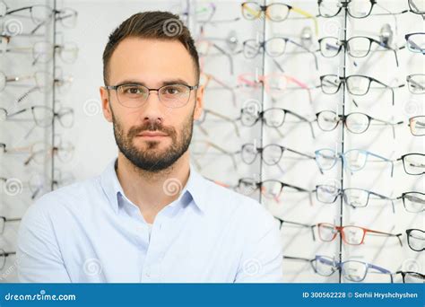 Man Chooses Glasses For Vision Correction In An Ophthalmology Salon
