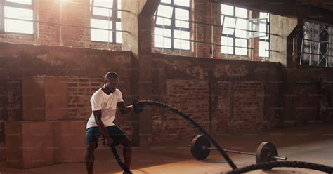 피트니스 운동 체육관에서 배틀 로프 운동을 하는 스포츠 남자 흑인 남성 운동선수 실내에서 무거운 로프로 기능성 피트니스 훈련 사진 Unsplash의 운동 이미지