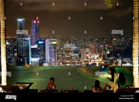 Enjoying Singapore City Skyline Night View At Mbs Infinity Pool Stock