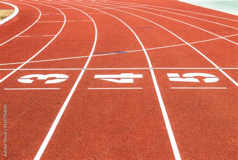 Empty Running Track With Lane Numbers In The Stadium Stock Photo