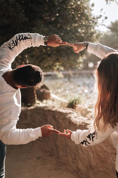 Shallow Focus Of The Back View Of A Couple With Hands Stretched
