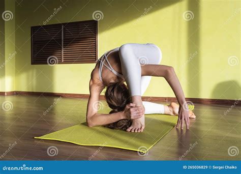 A Young Woman Leading A Healthy Lifestyle And Practicing Yoga Performs