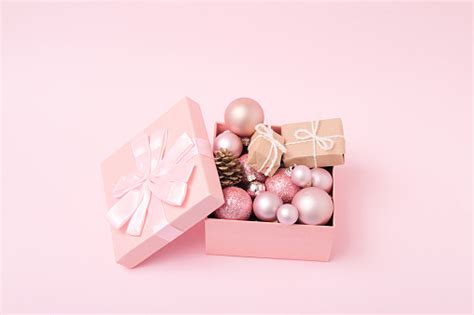 파스텔 핑크 배경에 핑크 상자에 빛나는 핑크 크리스마스 공 소나무 콘과 선물 상자 새해 복 많은 새해와 크리스마스 2022 축하 공간을 복사합니다 0명에 대한 스톡 사진 및