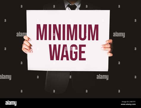 Minimum Wage Concept Background With Employee Holding Cardboard Stock