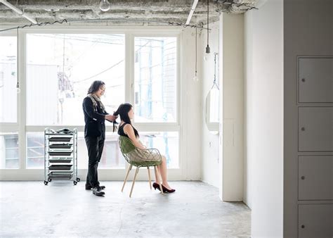 Hair Salon With An Exposed Ceiling And Twisting Lights By Sides Core