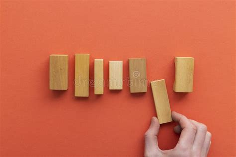 Hand Choosing A Wooden Block From A Set Business Choice Concept Stock
