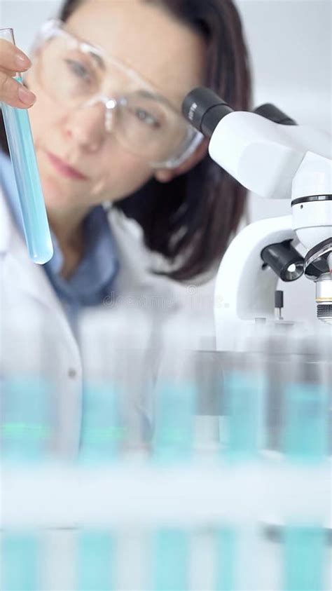 Female Scientist Analyzing Sample In Laboratory Focused Woman