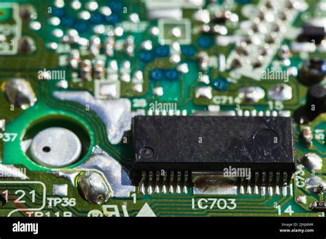 Chip And Capacitors Mounted On A Green Printed Circuit Board Close Up