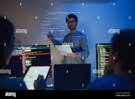 Asian And Indian Developer Team Brainstorming And Presentation About Ai Coding Project At Night