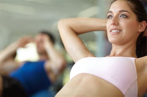 Keeping Positive About Her Fitness Level Two People Doing Exercises On