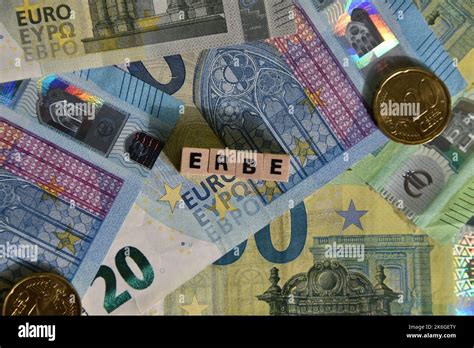 The German Word For Heritage With Wodden Cubes And Euro Bills Stock
