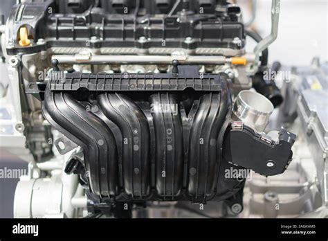 Detailed Look At A Contemporary Engine Intake Manifold Showcasing Its Advanced Design And Key