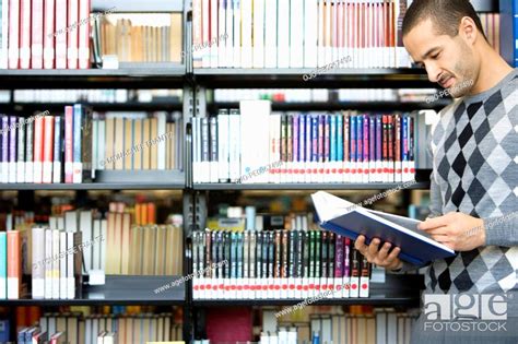 Man In Library Reading Book Stock Photo Picture And Royalty Free Image Pic OJO PE0067490