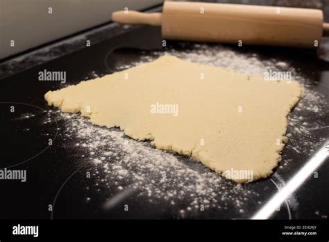 Raw Dough Flattened With Wooden Rolling Pin Stock Photo Alamy