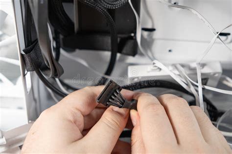 Technician Connecting Black Sata Power Cable Inside Computer Case During Pc Build Or Hardware