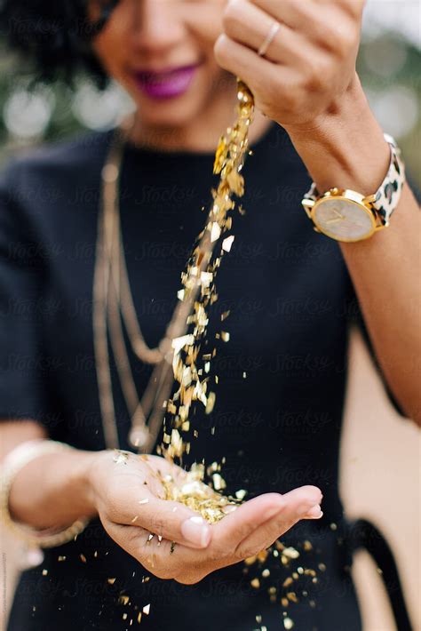 Woman Pouring Gold Glitter Confetti In Her Hands By Stocksy