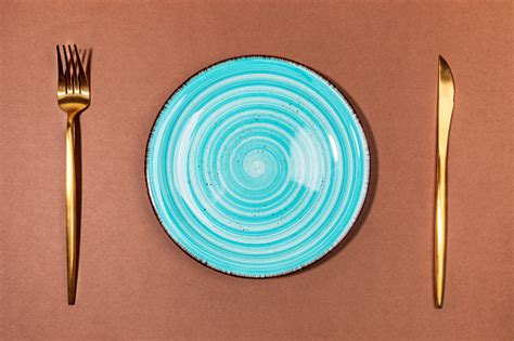 둥근 빈 청록색 접시와 갈색 배경에 황금색 칼 붙이 나이프와 포크 평면도 모형 가을에 대한 스톡 사진 및 기타 이미지 가을 갈색 개념 Istock