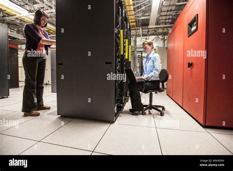 Caucasian Women Technicians Working On Computer Servers In A Server Farm Stock Photo Alamy