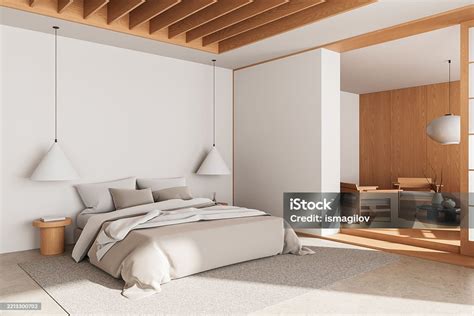 나무 천장과 따뜻한 뉴트럴 톤의 현대적인 가구가 돋보이는 미니멀한 침실은 자연 채광과 나무 질감의 아늑한 좌석 공간과 연결되어 있습니다 3d 렌더링 0명에 대한 스톡 사진
