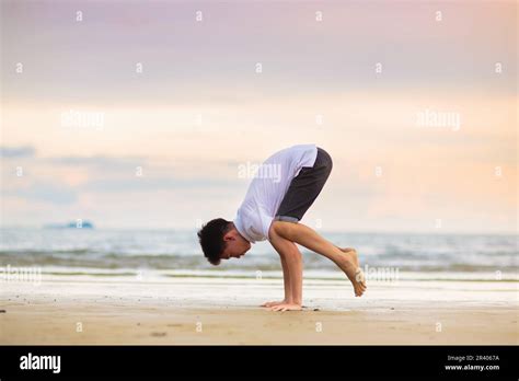 Teenager Doing Calisthenics Exercise Beach Yoga At Sunset Teen Boy
