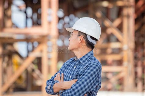 Engineer Checking Project At A Building Site Man In Hardhat With Arms Crossed At The