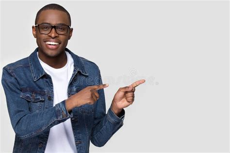 Smiling African Man Wearing Glasses Looking At Camera Pointing Aside Stock Image Image Of