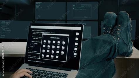Hacker Feet Up To Table Hacker With Laptop Coding Exploit To Crack Code Tracing Contact And