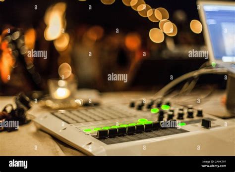 Musical Instrument Control Panel With Buttons And Sliders And A Laptop At The Background During