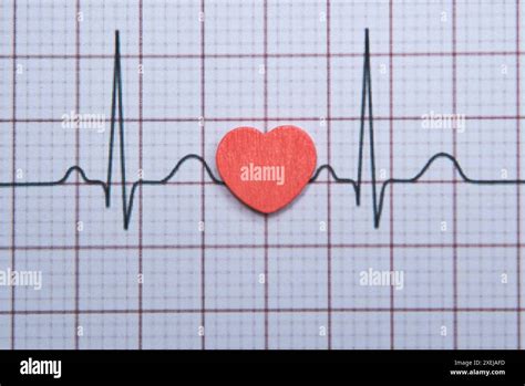 Closeup Image Of A Red Heart On A Electrocardiogram Ecg Printout The Ecg Graph Shows A Normal