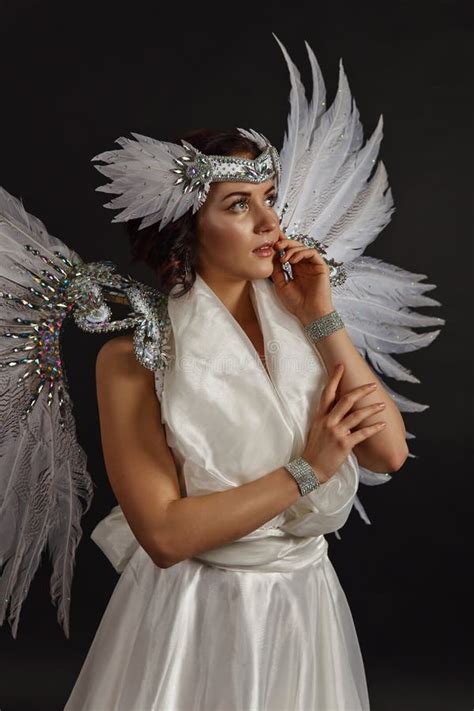 Beautiful Young Model Wearing A White Dress With Angel Wings In Stock