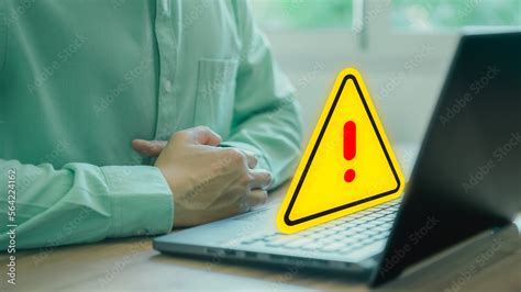 Adult Man Using Computer Laptop With Triangle Caution Warning Sign For