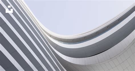 하늘을 배경으로 한 곡선 건물 사진 Unsplash의 무료 회색 이미지