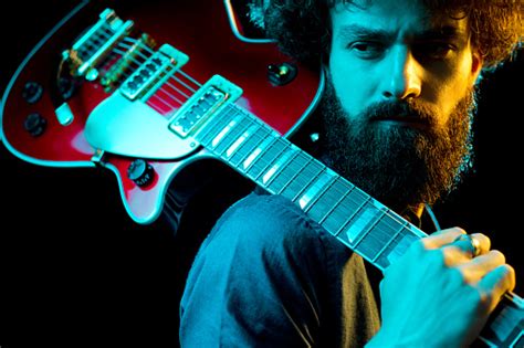 네온 불빛에 레드 기타와 힙 스 터 남자의 클로즈업 사진 록 뮤지션은 일렉트릭 기타를 연주하 고 있습니다 가수에 대한 스톡 사진 및 기타 이미지 Istock