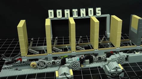 This Lego Machine Sets Up And Knocks Down Dominoes On An Infinite Loop Nerdist