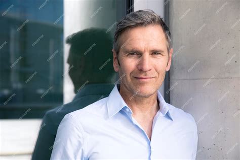 Premium Photo Portrait Of Confident Mature Businessman At A Glass Front