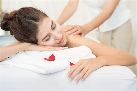 Premium Photo Midsection Of Masseur Massaging Young Woman On Table In Spa