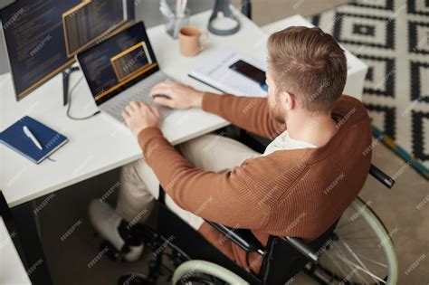 Premium Photo Man With Disability As Programmer Writing Code In Office