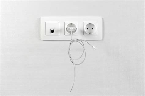검은 색 연결 인터넷 플러그와 흰색 와이어와 벽에 전기 소켓 Usb 입력이 연결 된 충전 장치의 어댑터 벽에 대한 스톡 사진 및
