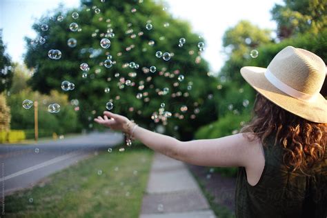 A Young Woman Blowing Bubbles By Stocksy Contributor Chelsea Victoria Stocksy