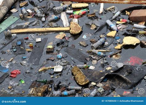 Trash And Garbage Floating On The Surface Of The Water Causing Sewage