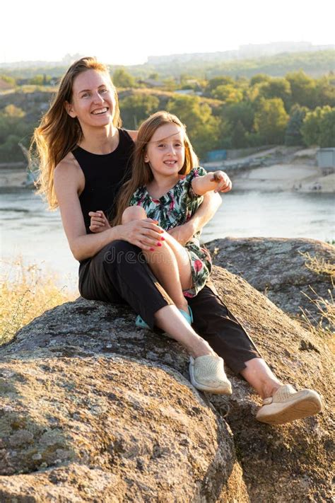 Mom And Daughter Point Fingers At Something In The Distance Happy