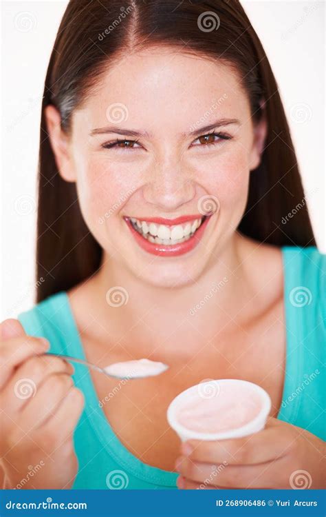 This Yoghurt Is Great Portrait Of An Attractive Brunette Woman Eating A Yoghurt Stock Photo