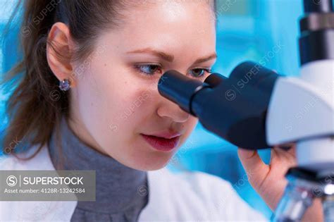 Female Scientist Using Microscope Superstock