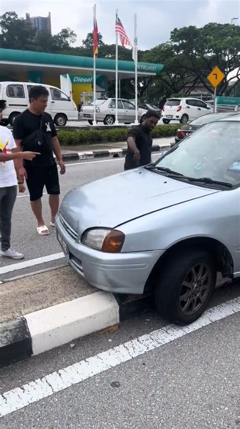 Babe Driver In M Sia Remains Calm After Car Mounts Road Divider Bystanders Gather To Help
