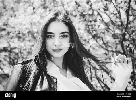 Young Beautiful Girl With Long Hair Enjoys The Beauty Of Spring Nature